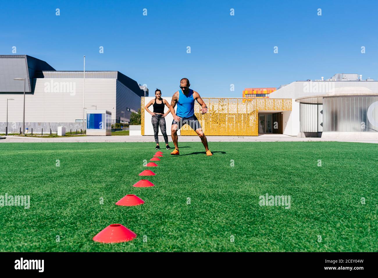Low angle of determined sportsWoman and sportsman running between ...