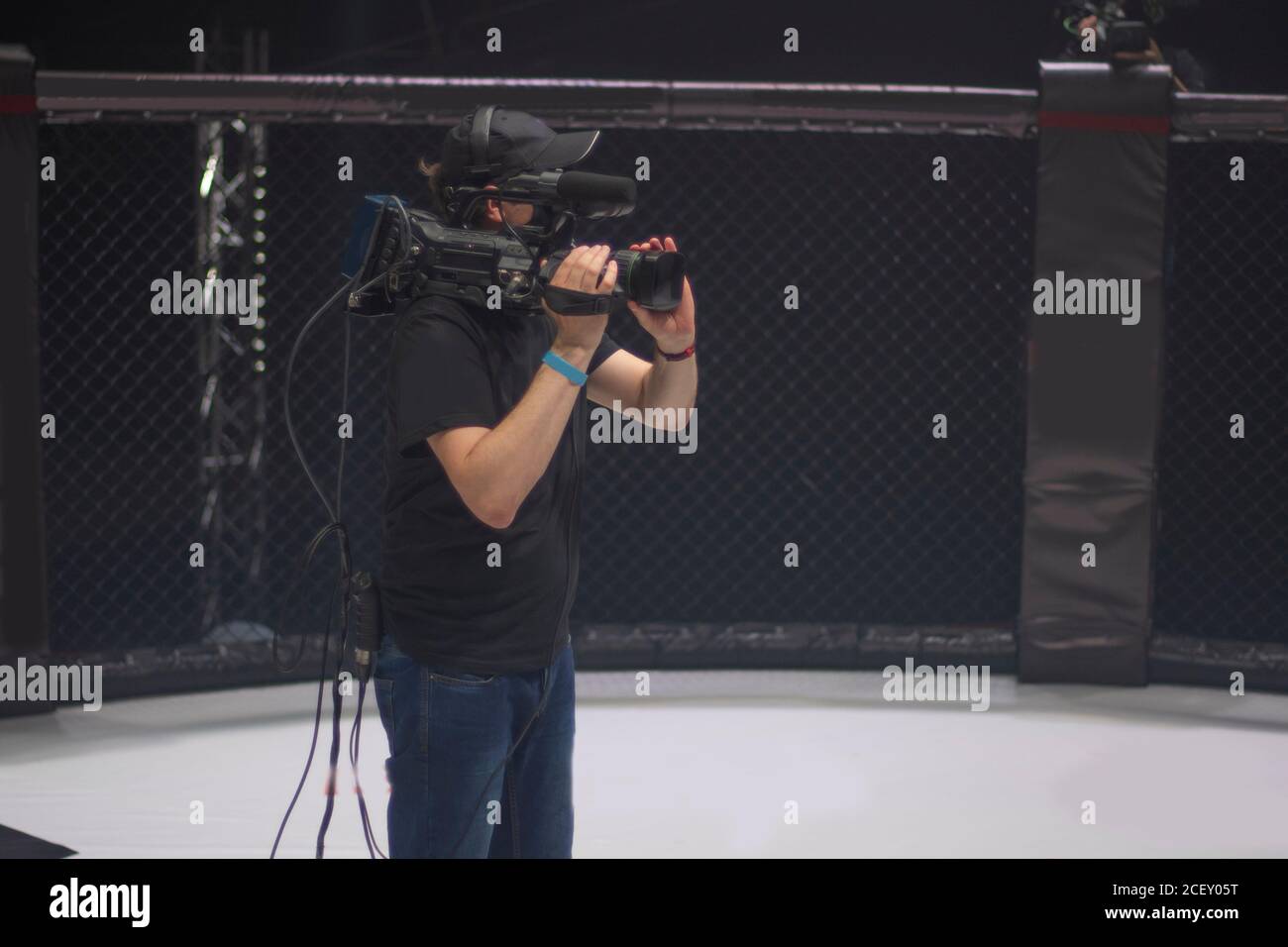 cameraman on the set of the ultimate fighting show. Masked against ...