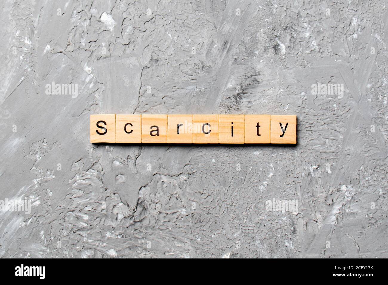 scarcity word written on wood block. scarcity text on cement table for ...