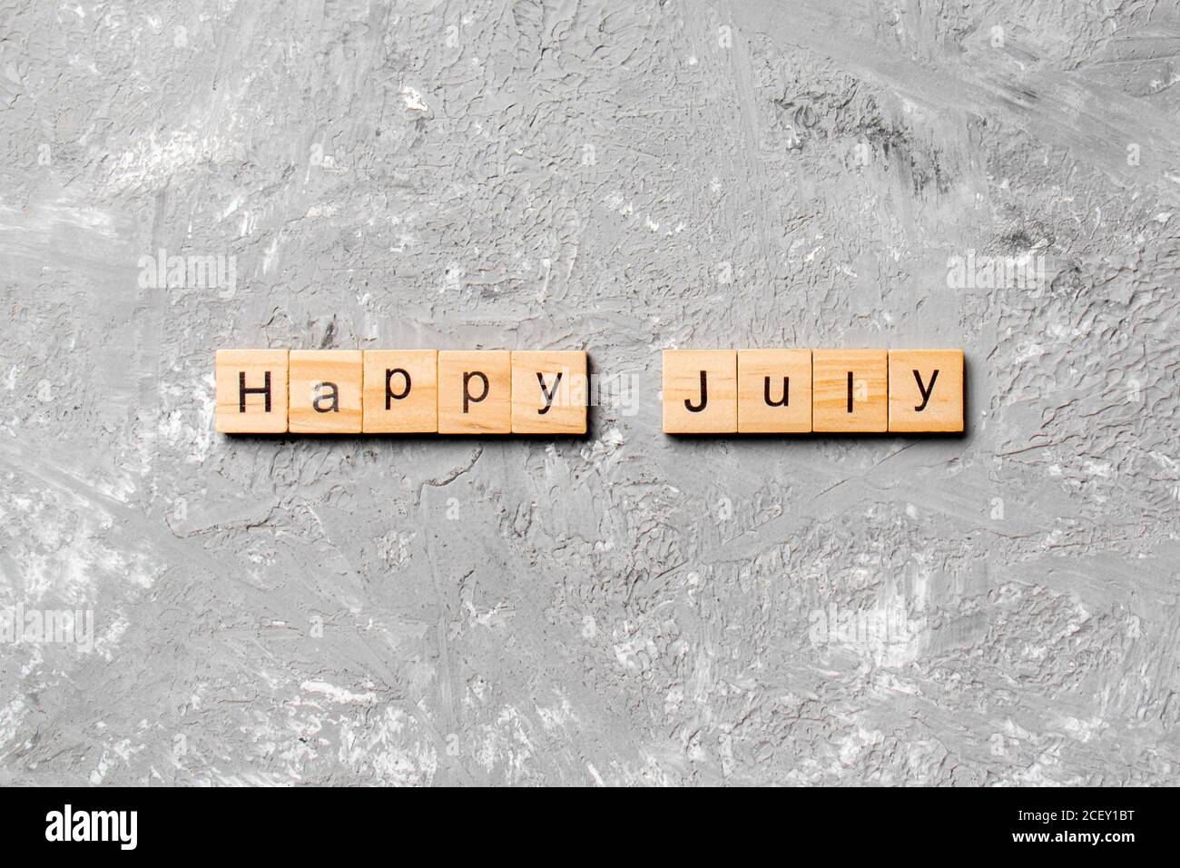 Happy july word written on wood block. Happy july text on table ...