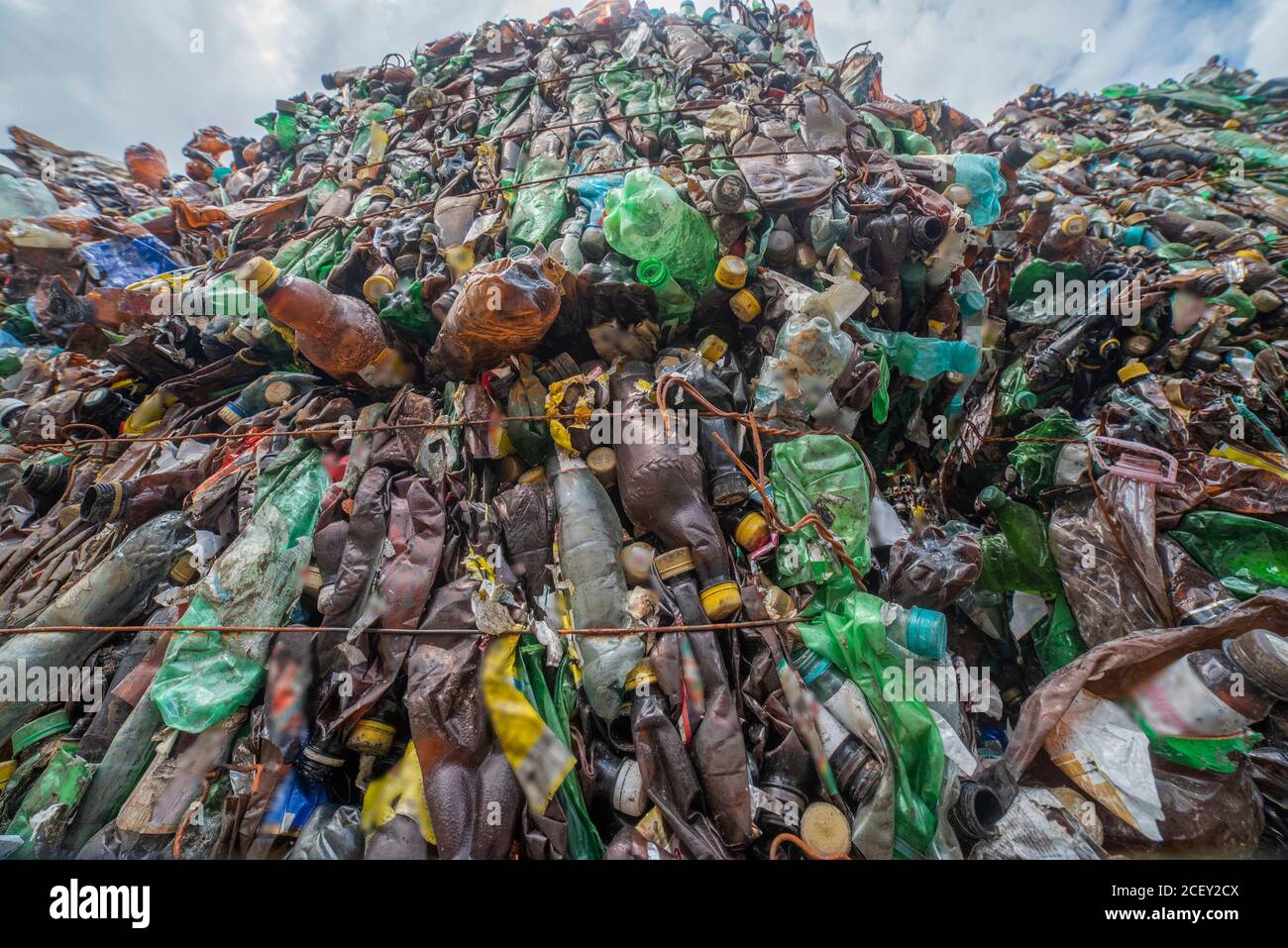 mountains of plastic bottles in a landfill for recycling. Waste ...