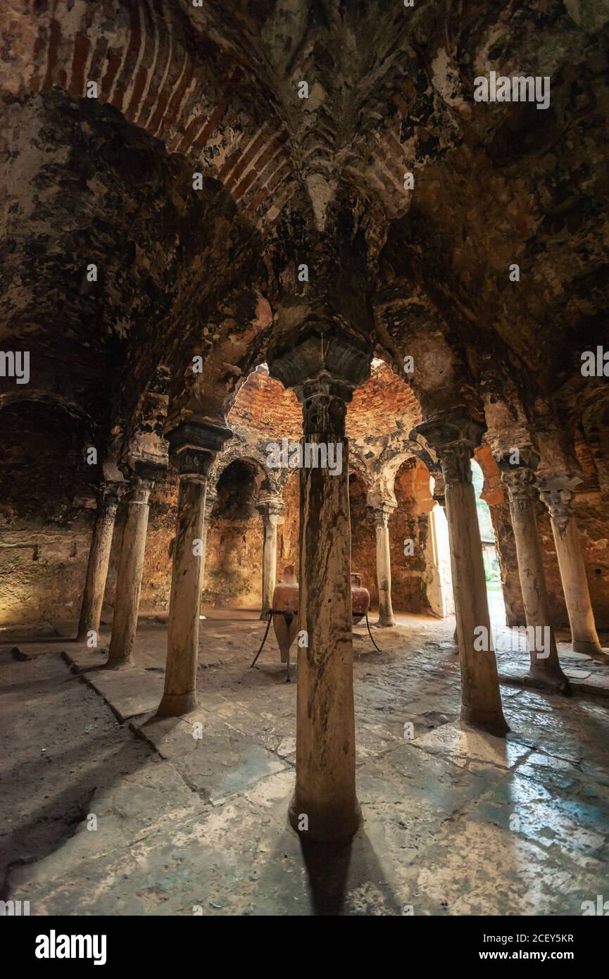 Low angle of interior of aged Arab Baths with tall stone columns and ...
