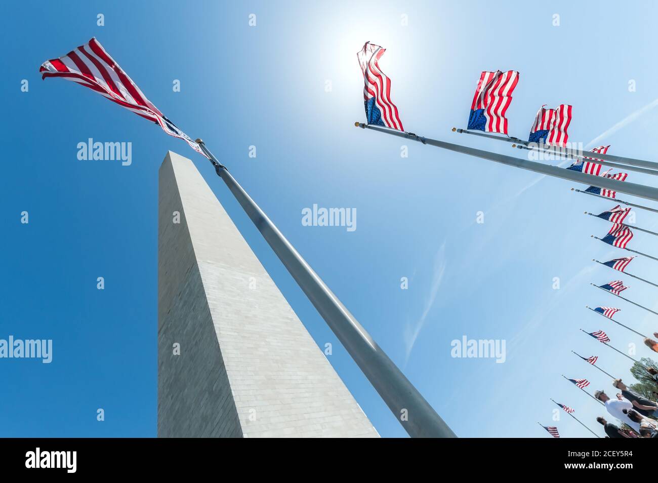 From below of Washington Monument surrounded by pillars with American ...