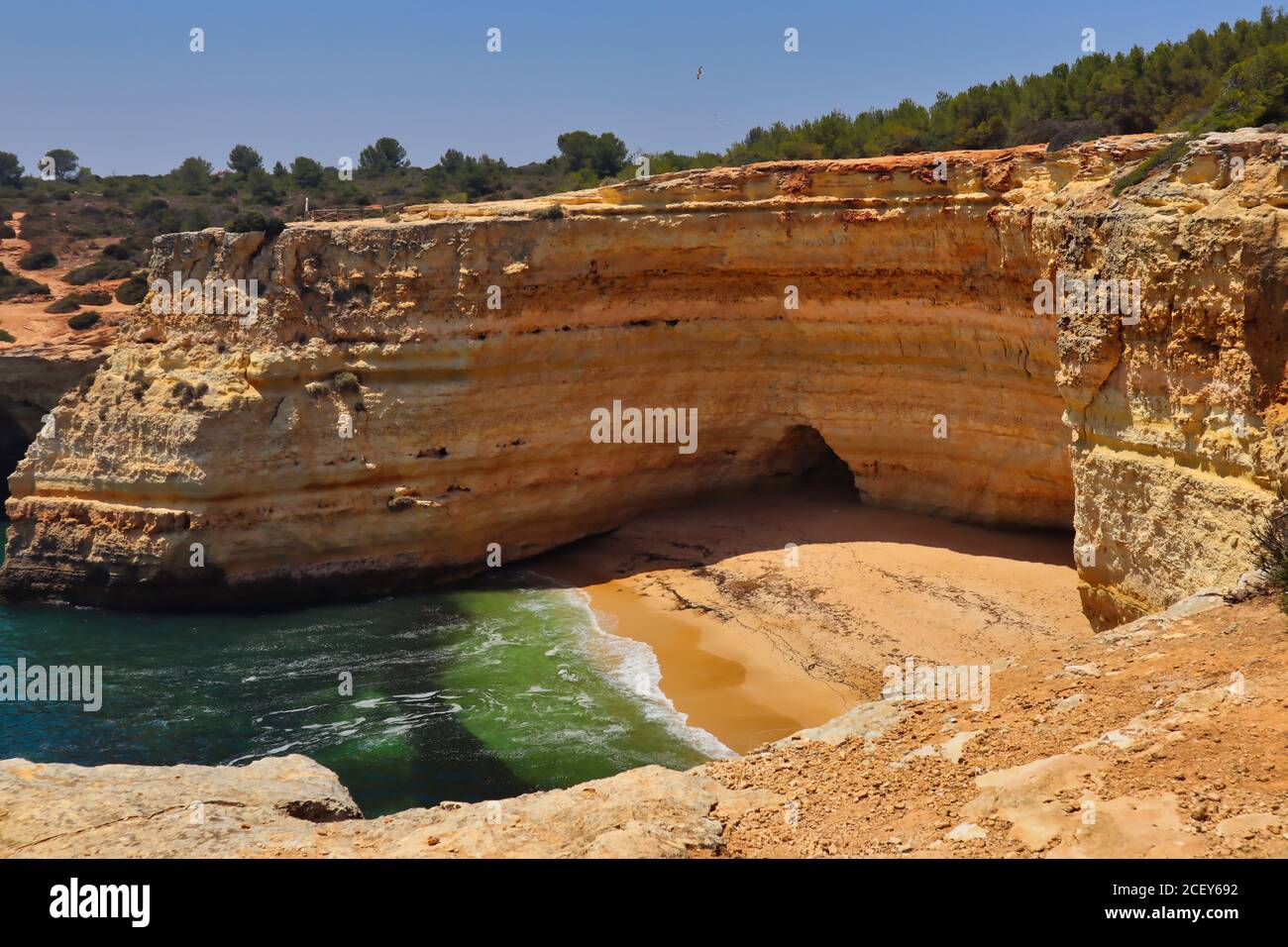 A picture of a beach with Atlanic ocean and its waves, sandstone cliffs ...