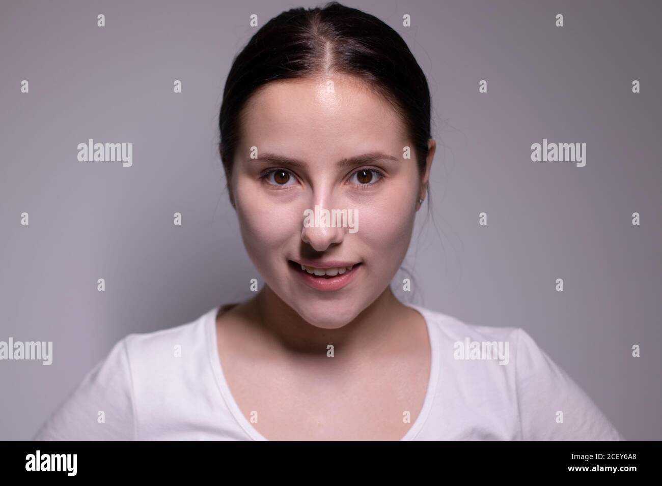 Indoor portrait of Beautiful smiling brunette with clean skin, natural ...
