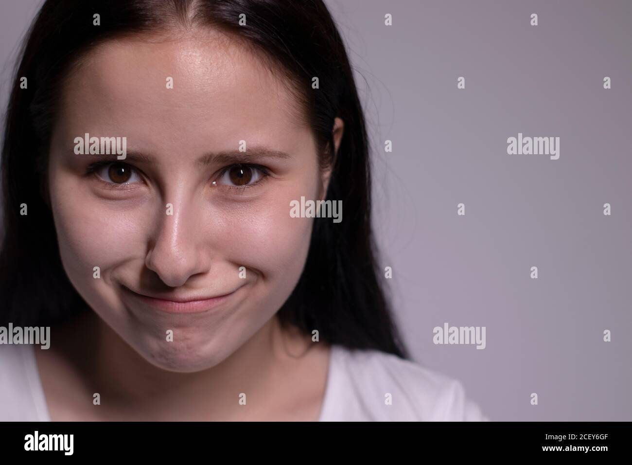 Indoor portrait of Beautiful smiling brunette with clean skin, natural ...