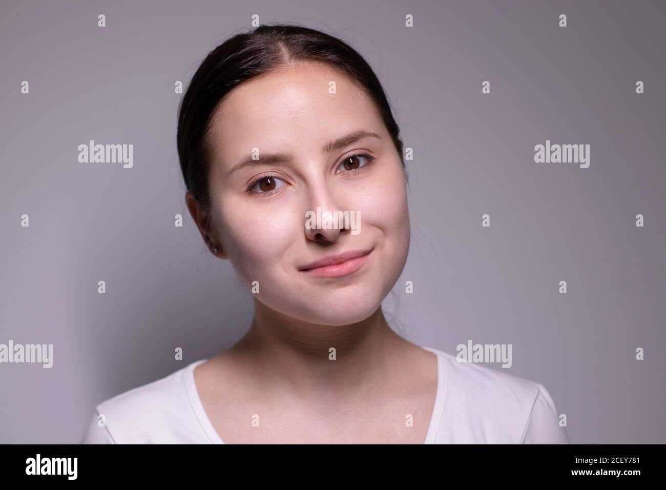 Indoor portrait of Beautiful smiling brunette with clean skin, natural ...