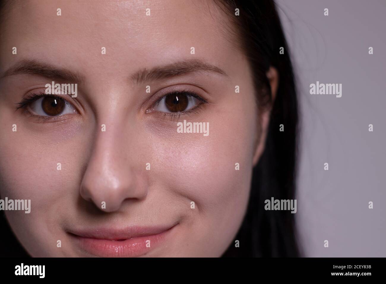 Indoor portrait of Beautiful smiling brunette with clean skin, natural ...