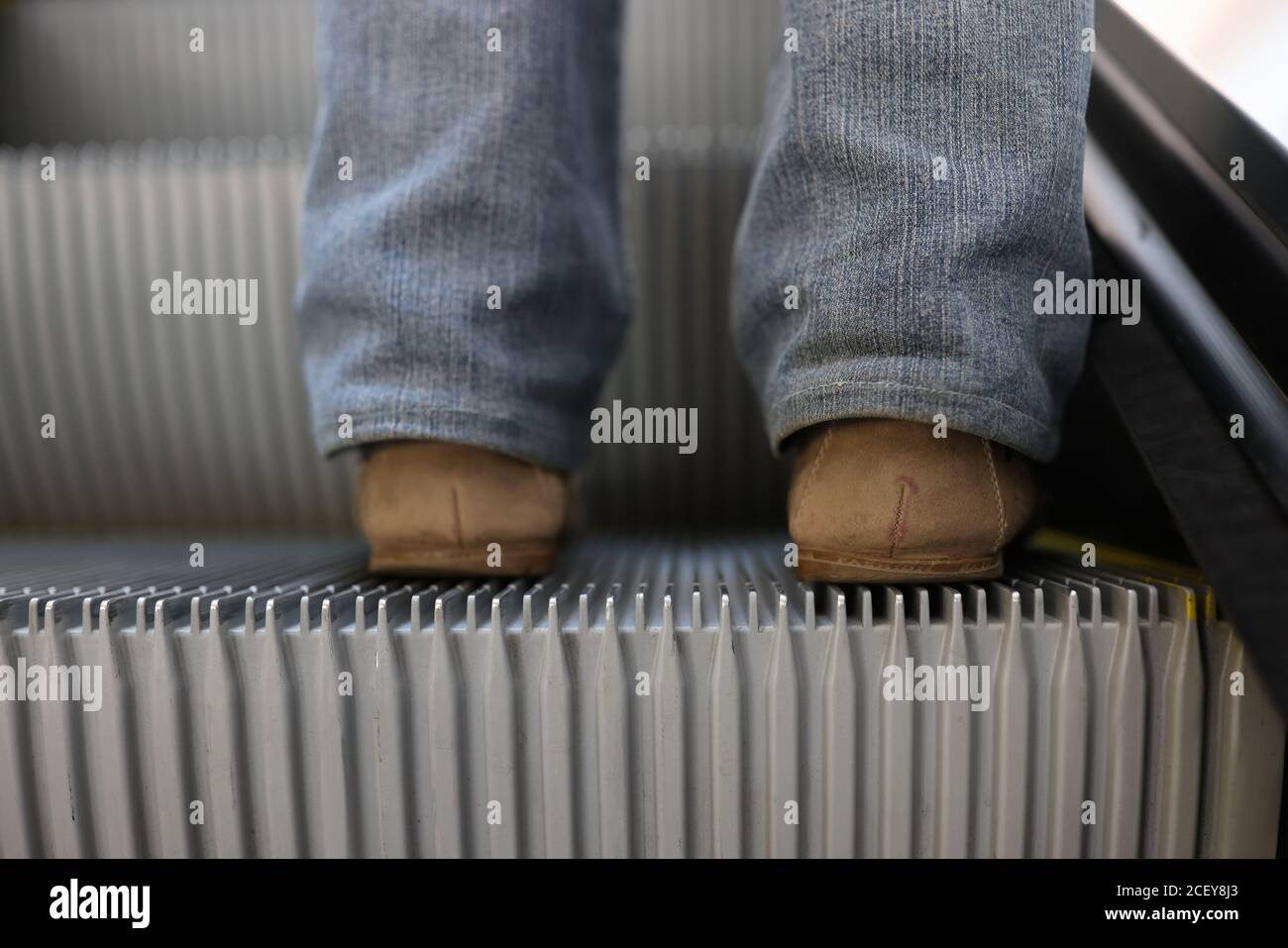 Male feet on step to the escalator closeup Stock Photo - Alamy