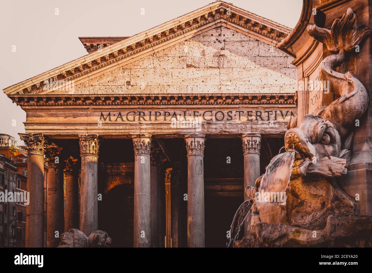 Fountain and the ancient roman Pantheon in Rome illuminated at sunset ...