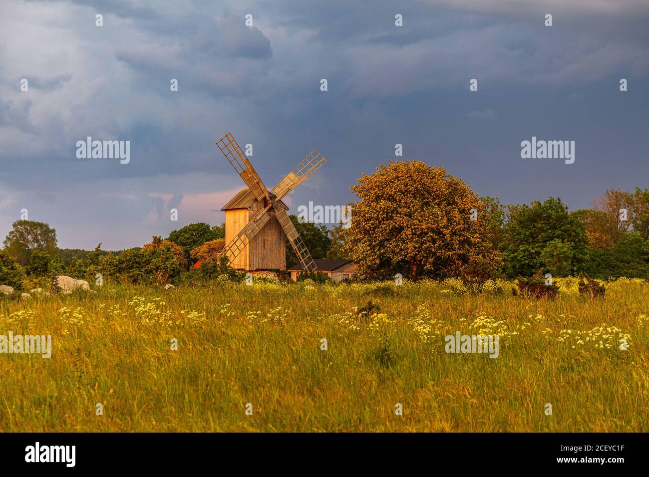 Dutch style wooden windmill at sunset Stock Photo - Alamy
