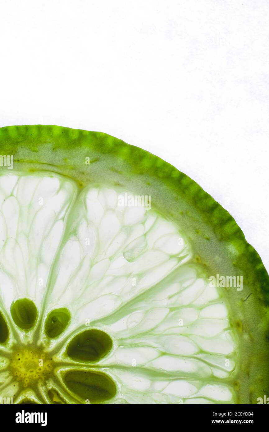 Half circle lime wedge on white background Stock Photo - Alamy