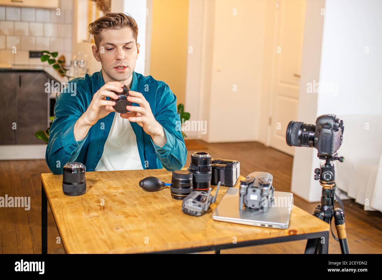 caucasian blogger man studying his new cameras, show DSLR on camera ...