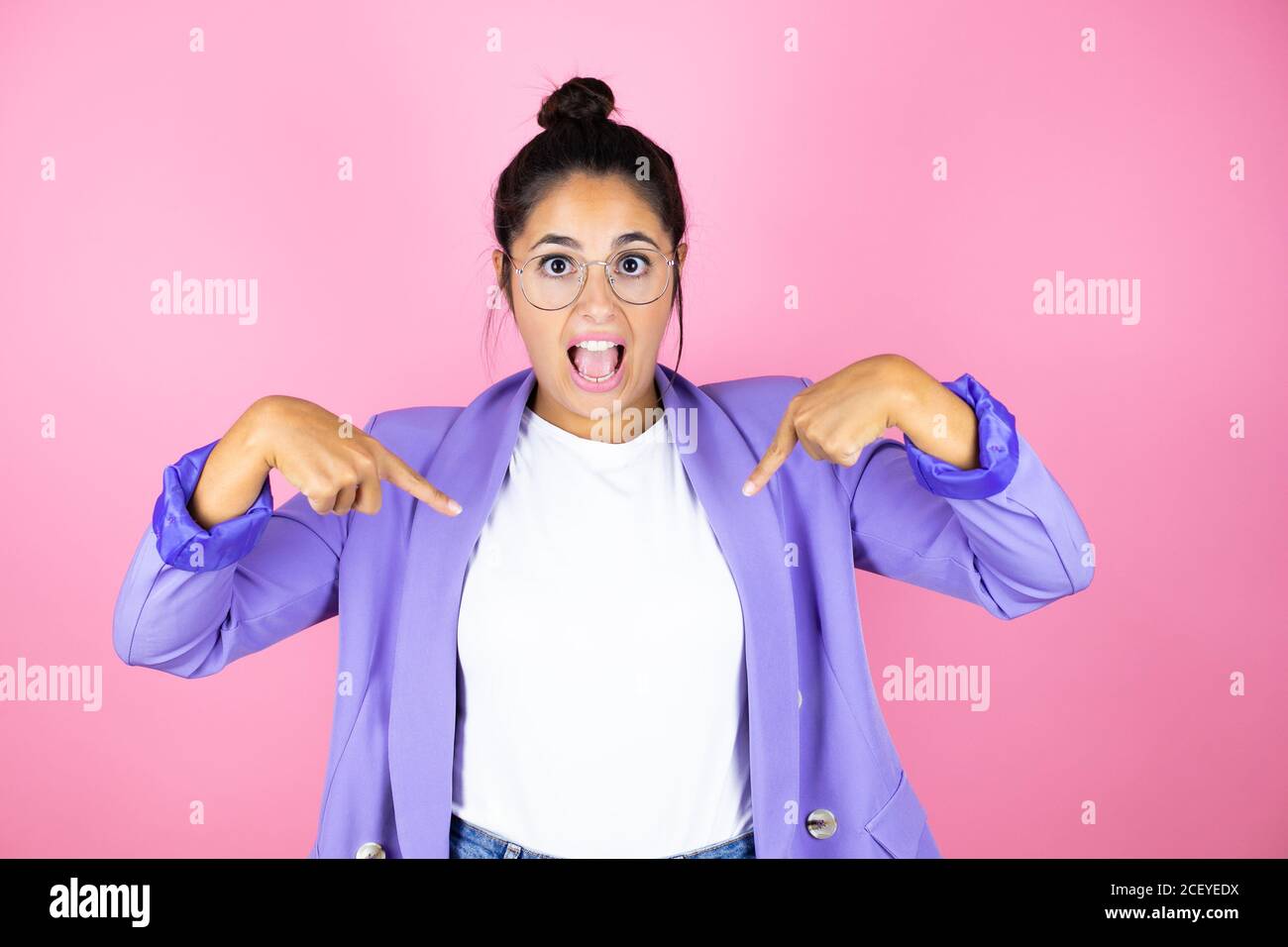 Young beautiful business woman over isolated pink background looking ...