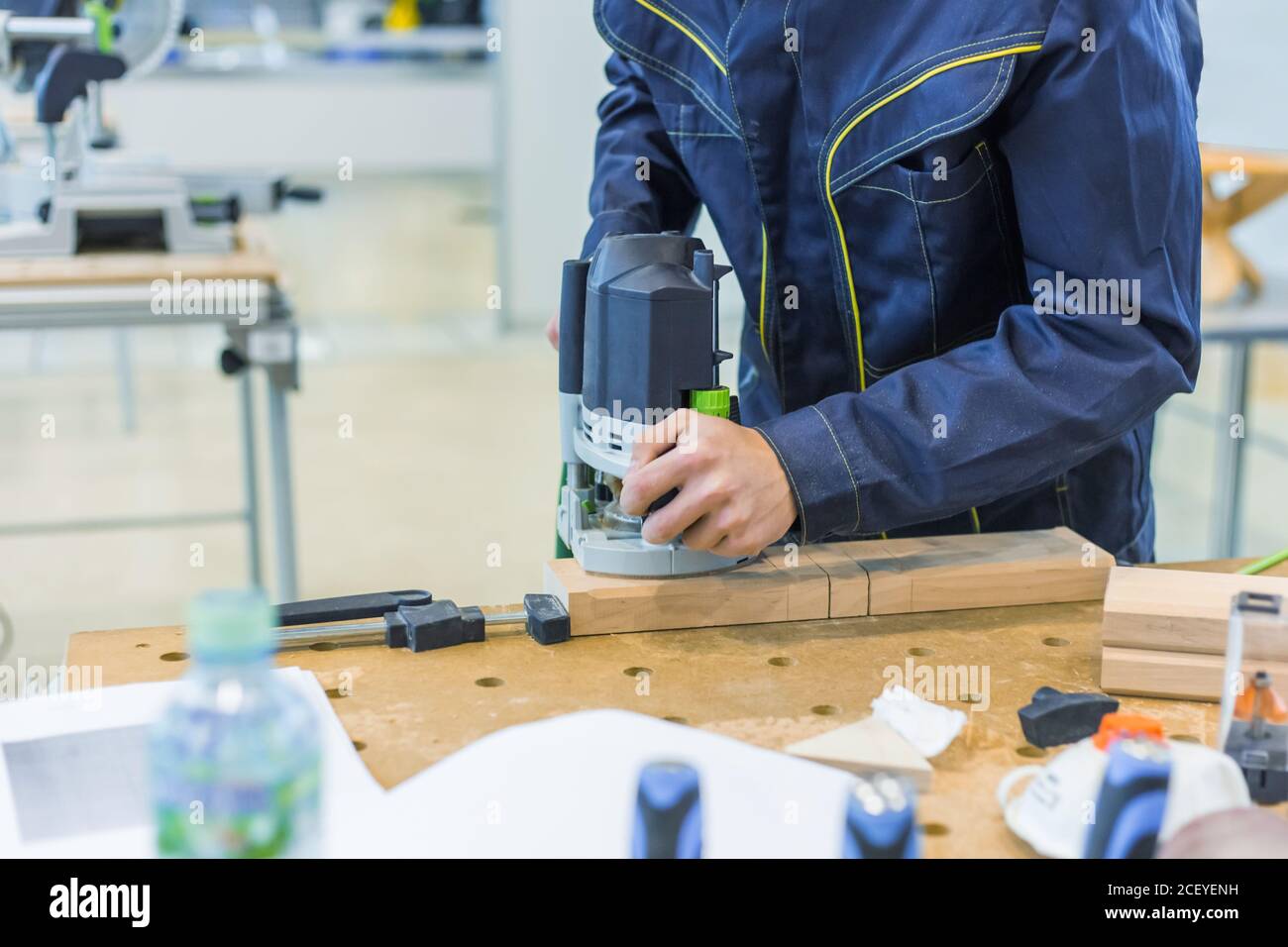 Professional man carpenter using electric sander to polish wood on ...