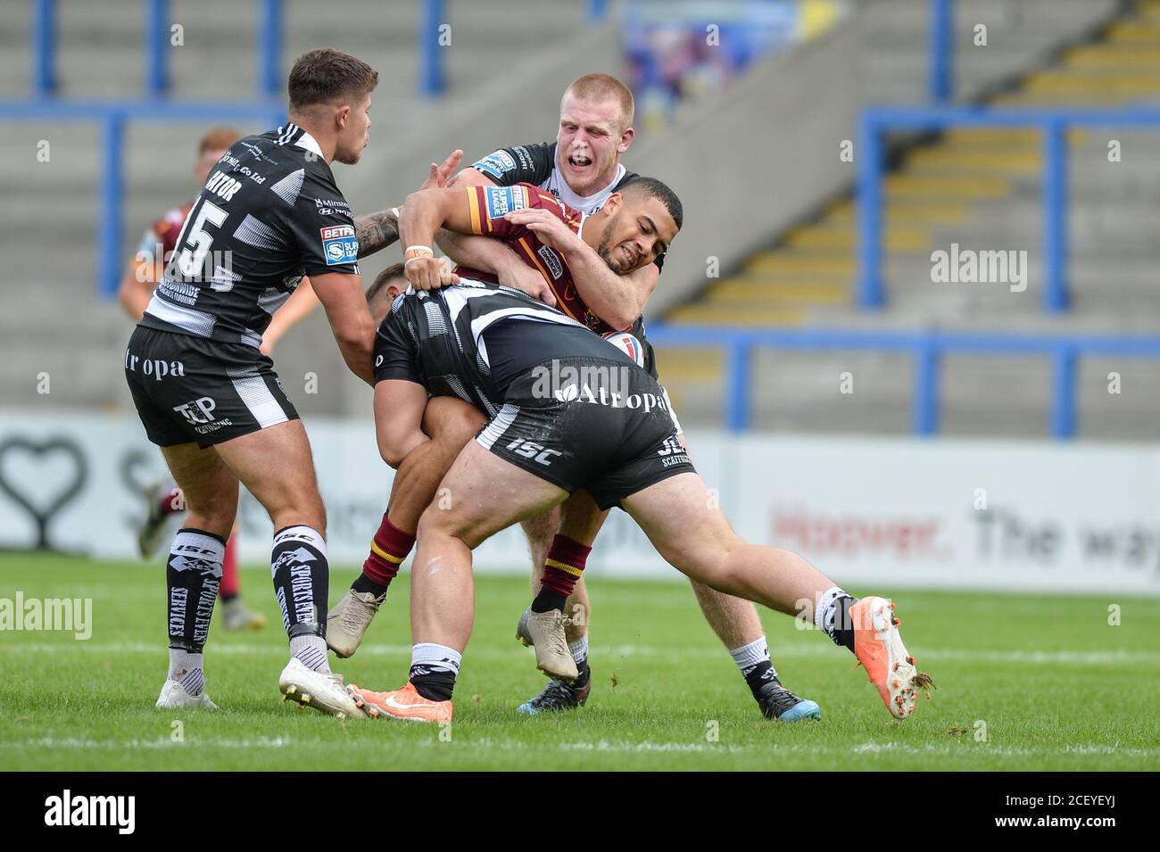 Darnell McIntosh of Huddersfield Giants wrapped up by Hull FC Stock ...
