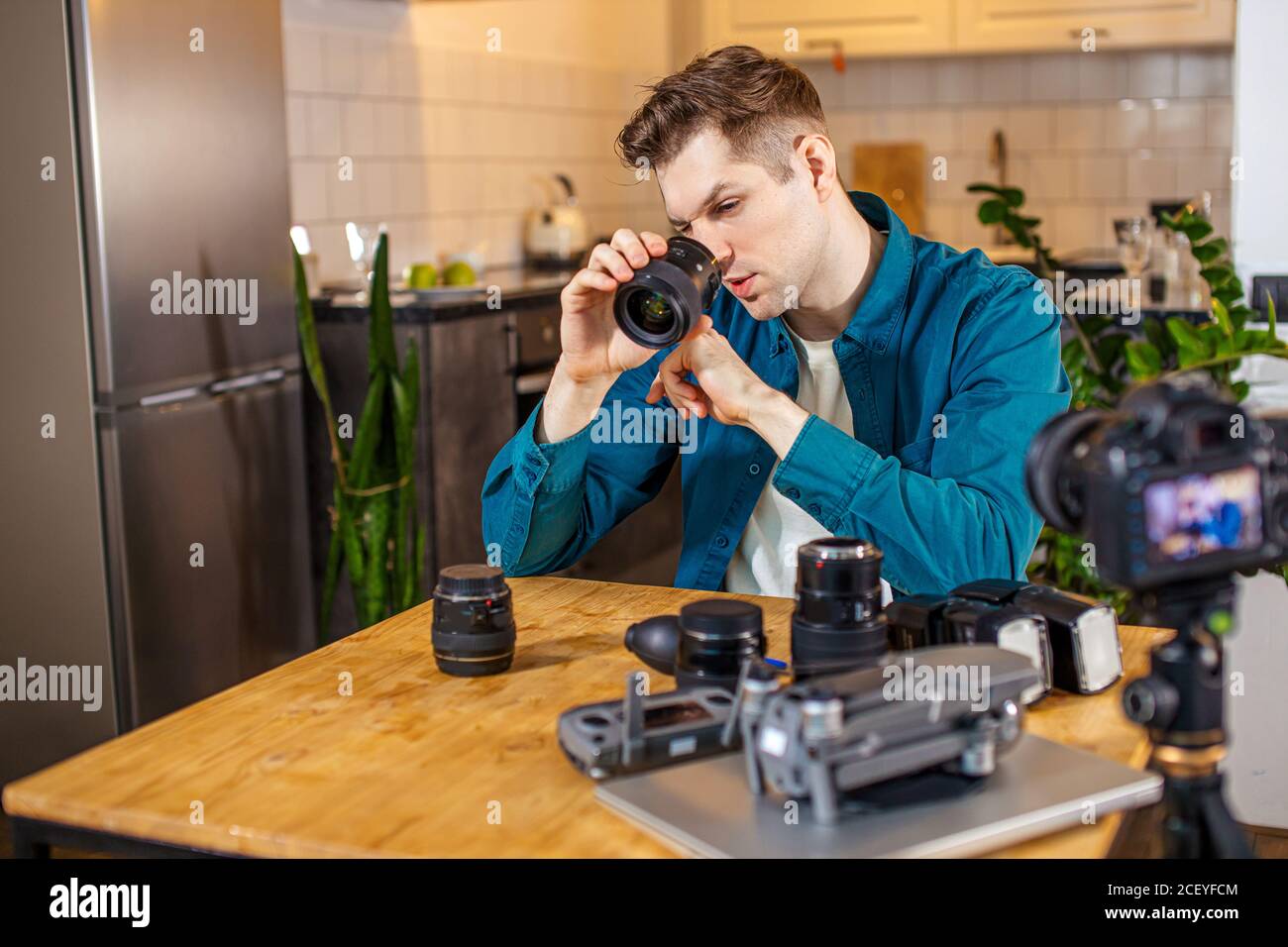 caucasian blogger man studying his new cameras, show DSLR on camera ...