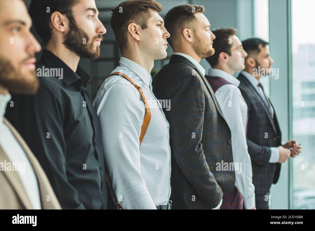 side view on young caucasian bearded business people looking side at ...