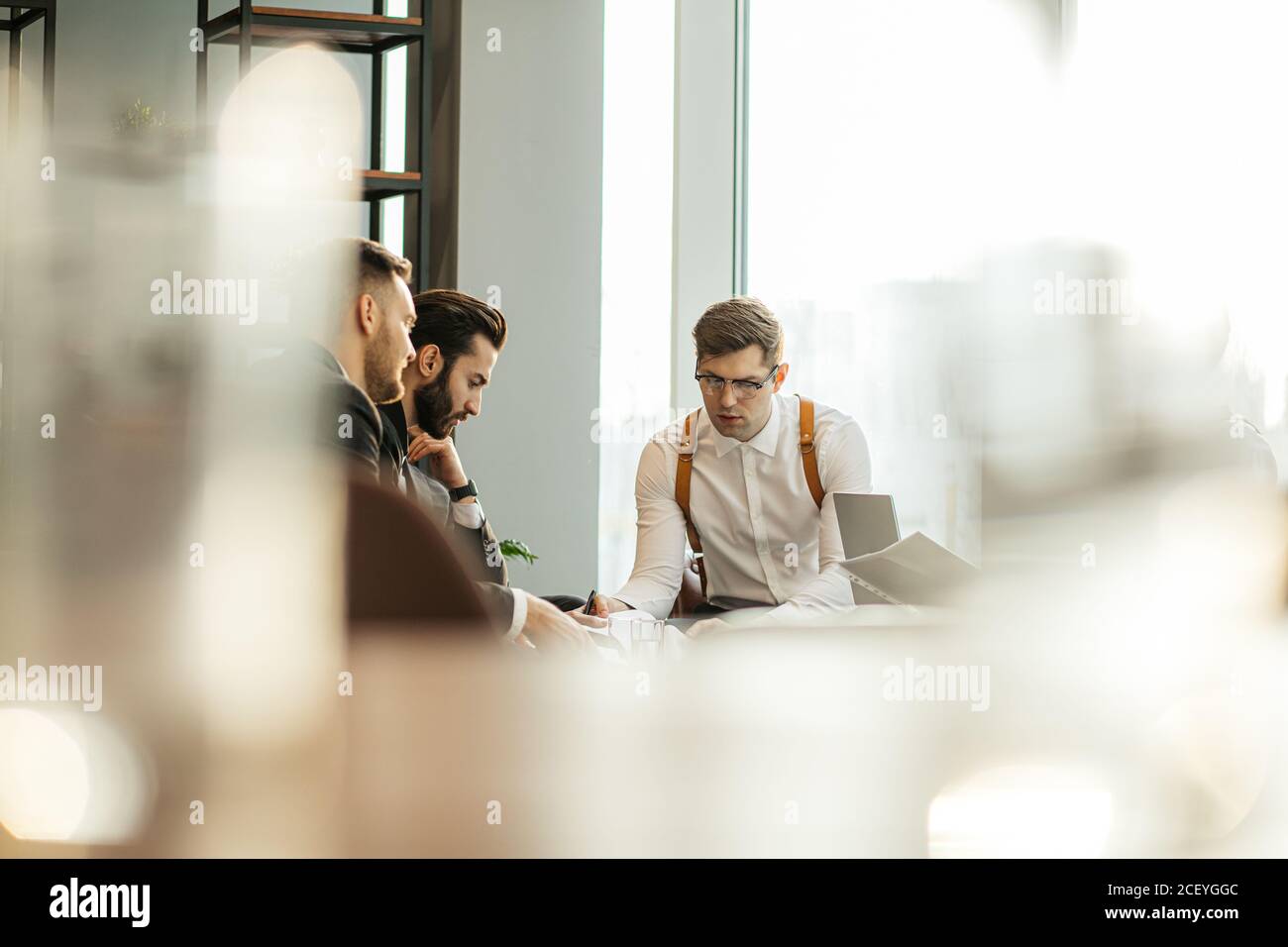 business people wearing formal wear gathered in office for holding ...
