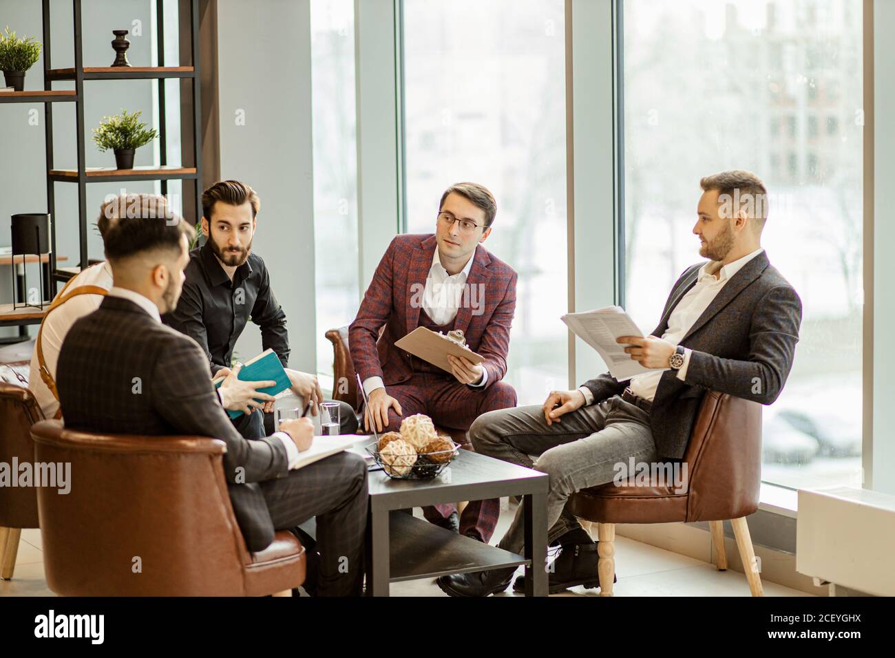 successful and confident caucasian men, business partners hold meeting ...