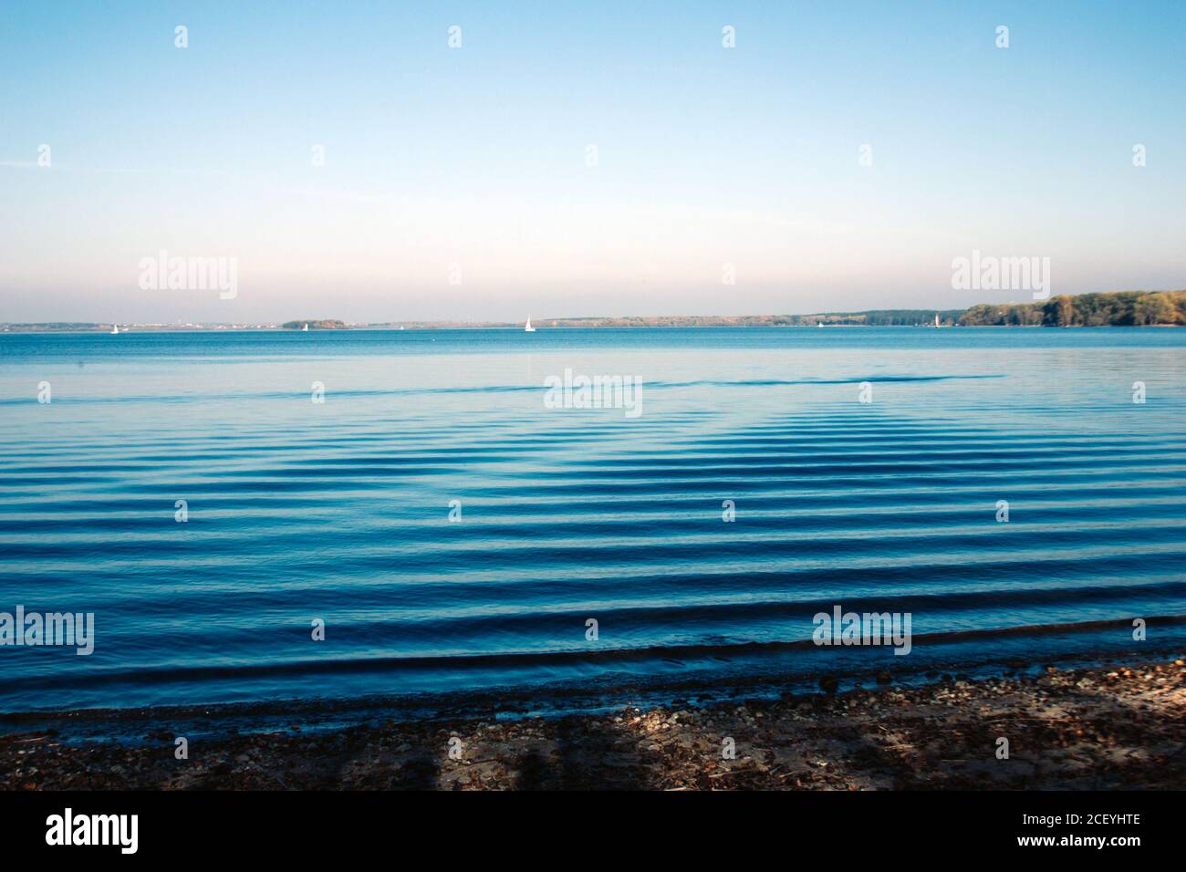 Beautiful lake landscape, and sunset. Blue waves and horizon line on ...
