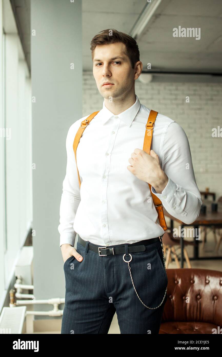 portrait of young personable man in tuxedo stand confidently looking at ...
