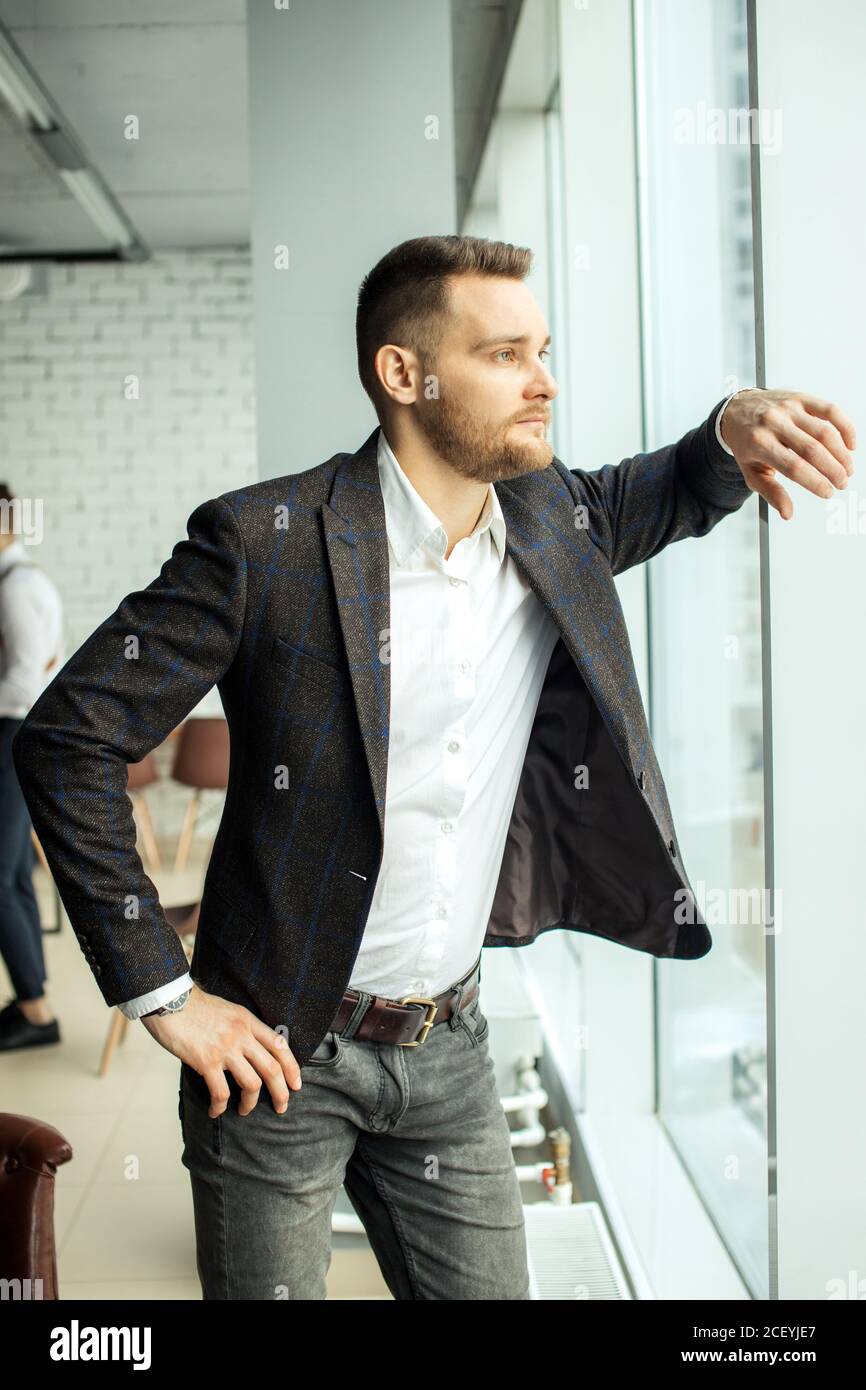 side view on elegant confident man in tuxedo, good-looking male stand ...