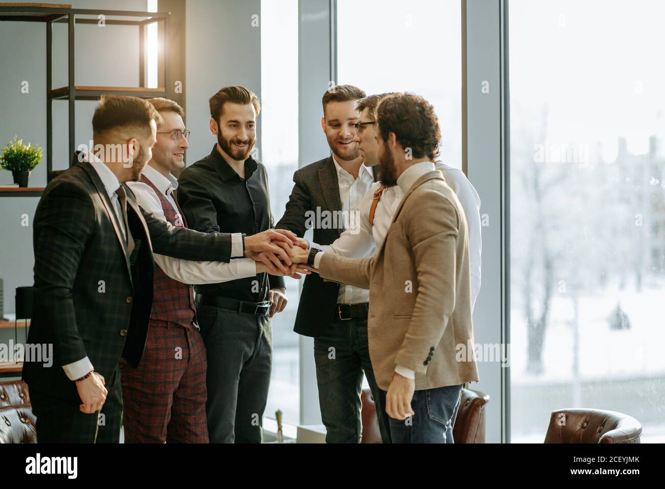 happy business team, business men in tuxedo joined hands in one ...