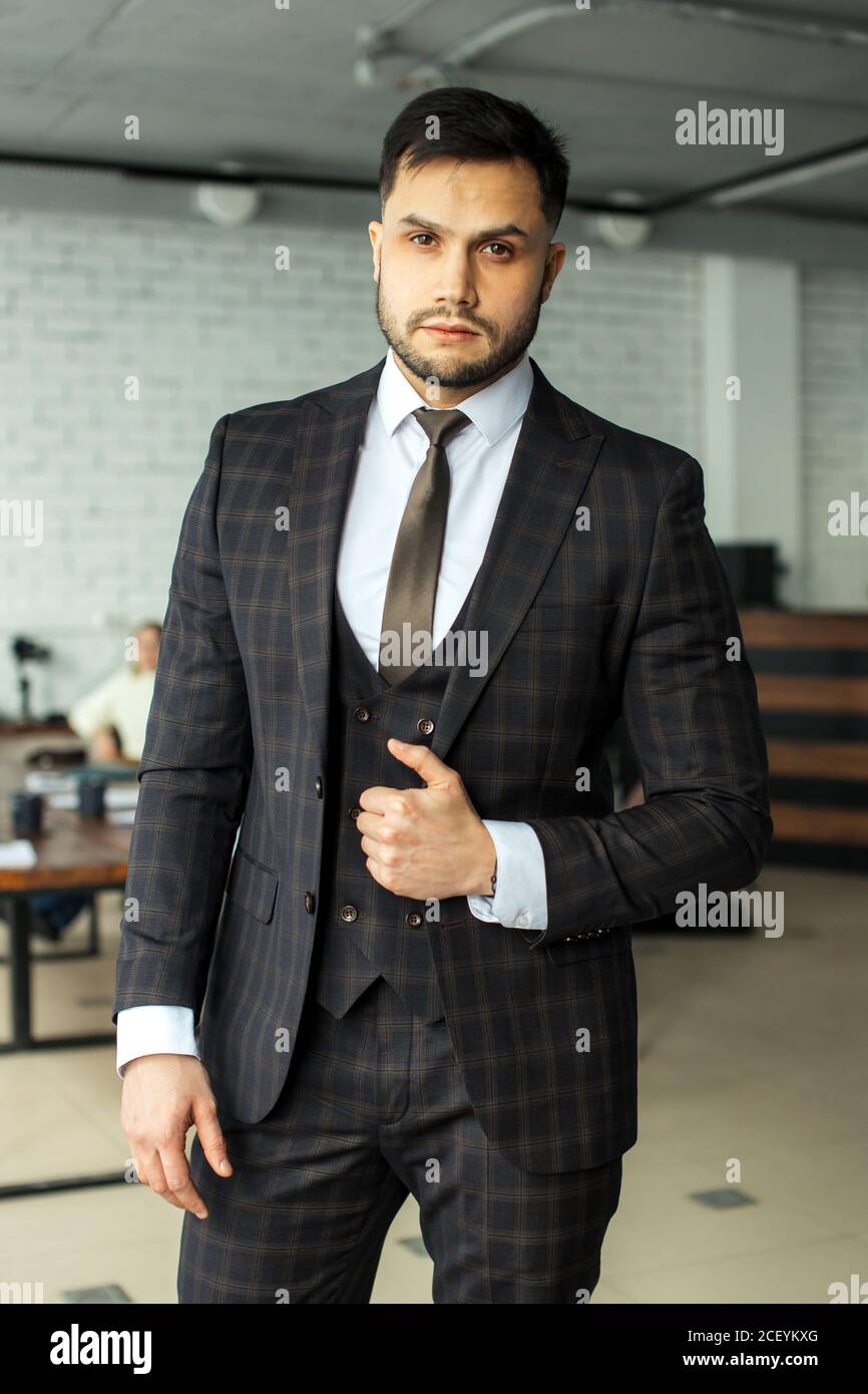 portrait of young personable man in tuxedo stand looking at camera in ...