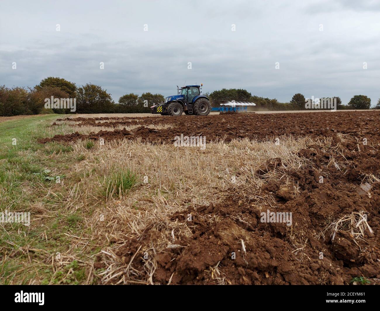 Tractor ploughing a field during the 2020 harvest Stock Photo - Alamy
