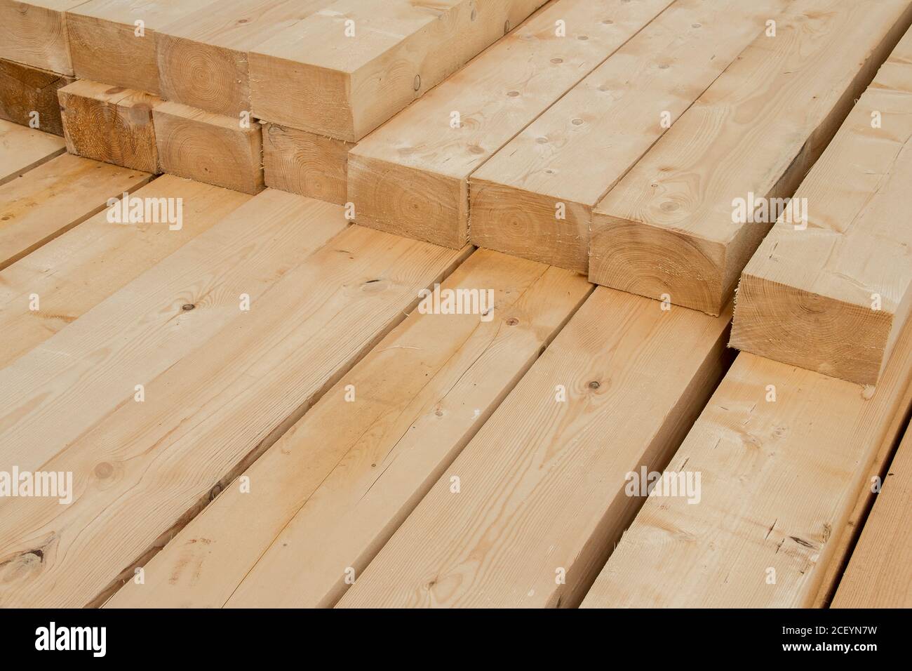 Piled wooden beams. Closeup big wooden boards. Stacked wooden beams of ...
