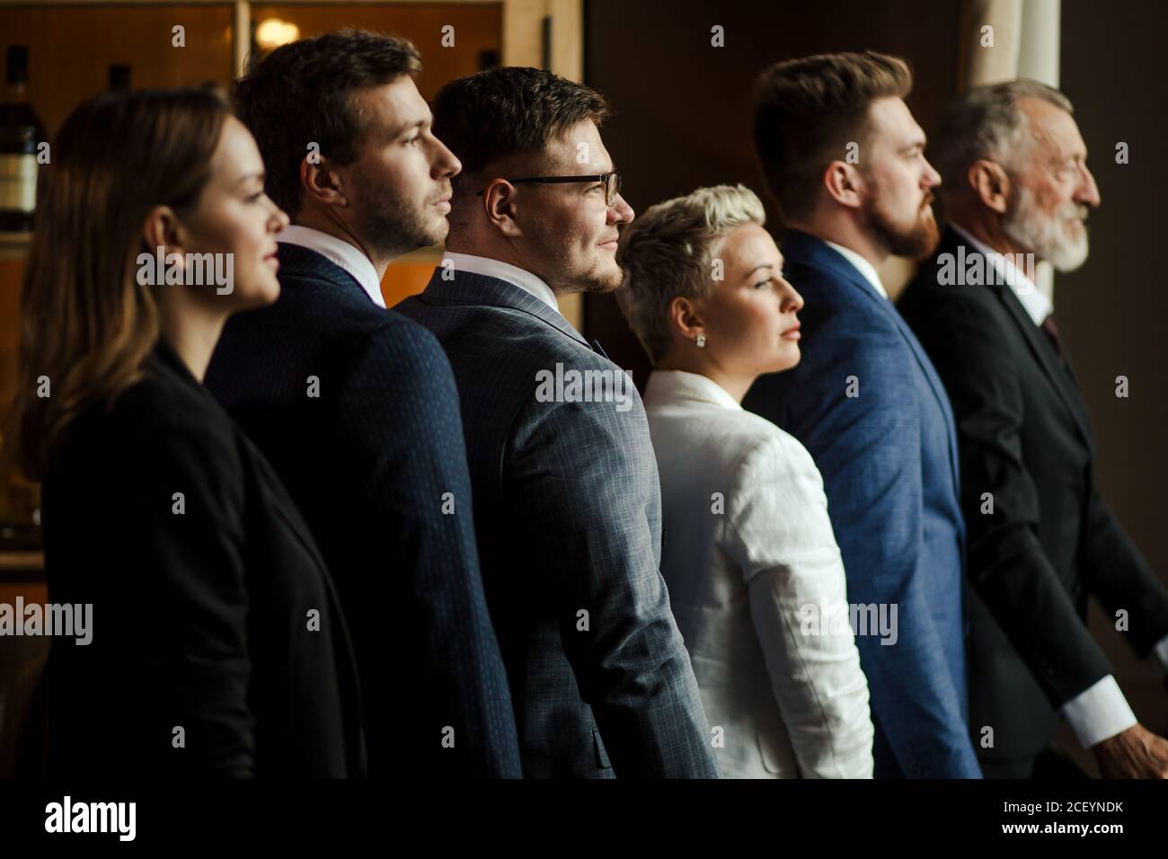 Portrait of self confident reserved people in business suites standing ...