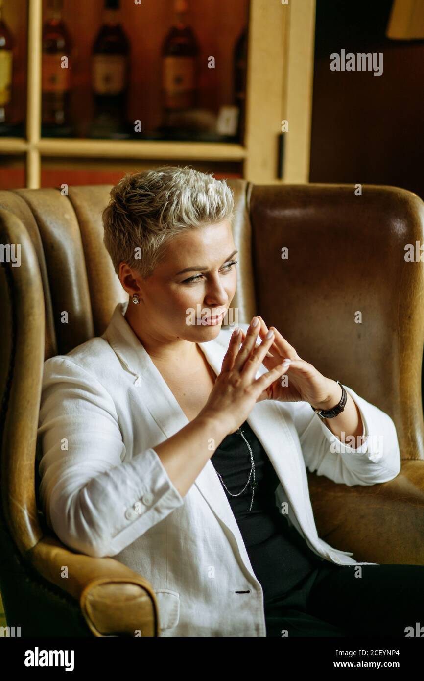 Portrait of lovely attractive business lady sitting with crossed legs ...