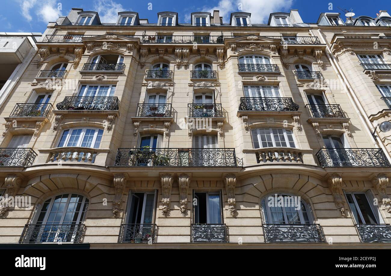 Traditional French house with typical balconies and windows. Paris ...
