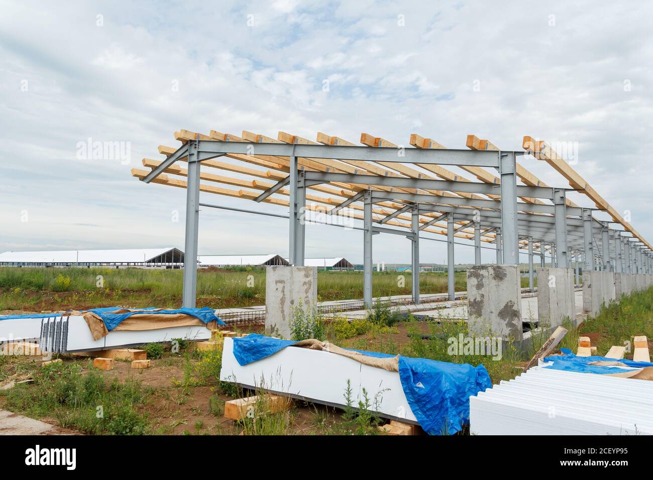 Wooden roof beams on the steel frame of a building under construction ...