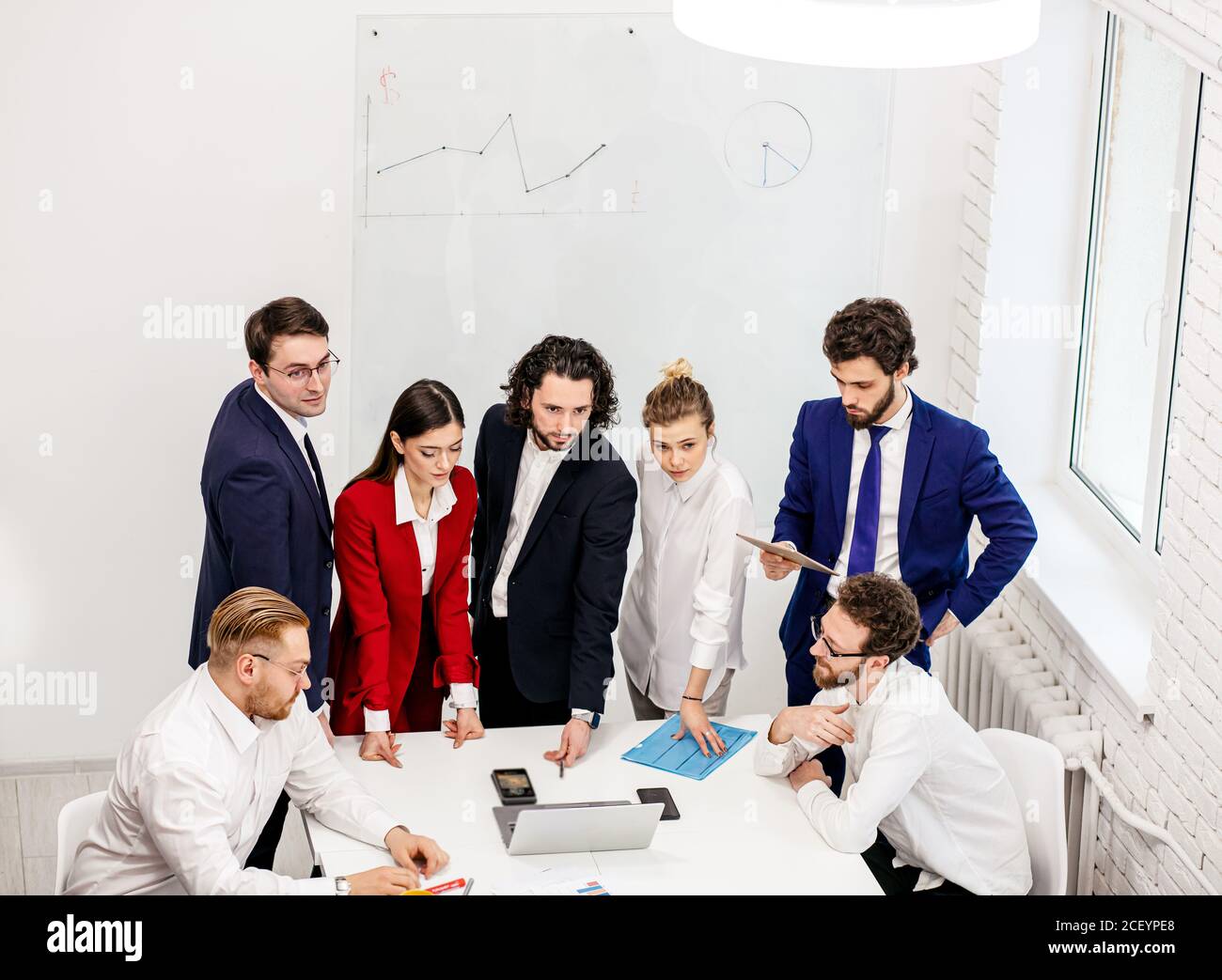 young business leaders gathered in modern office for discussion ...