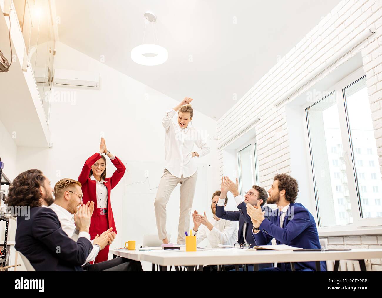 happy caucasian business people in office celebrate their win in ...