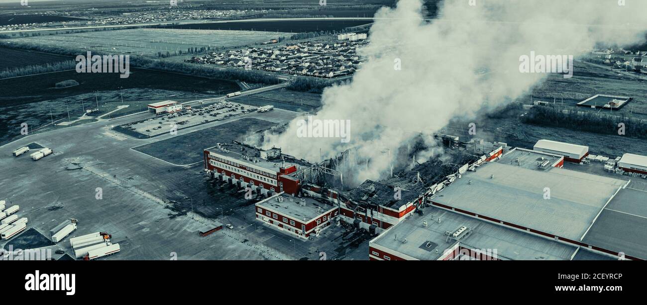 Aerial view of fire in burning industrial factory building with big ...