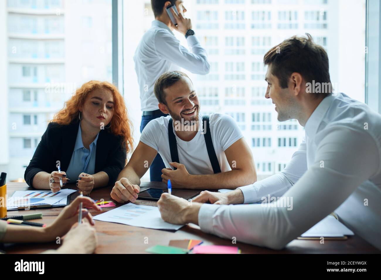 Solving problems as one team. Caucasian young team of male and female ...
