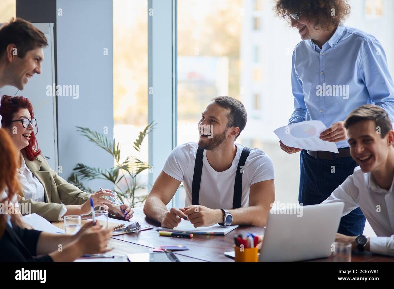 Team of cheerful caucasian business people in smart formal wear sitting ...