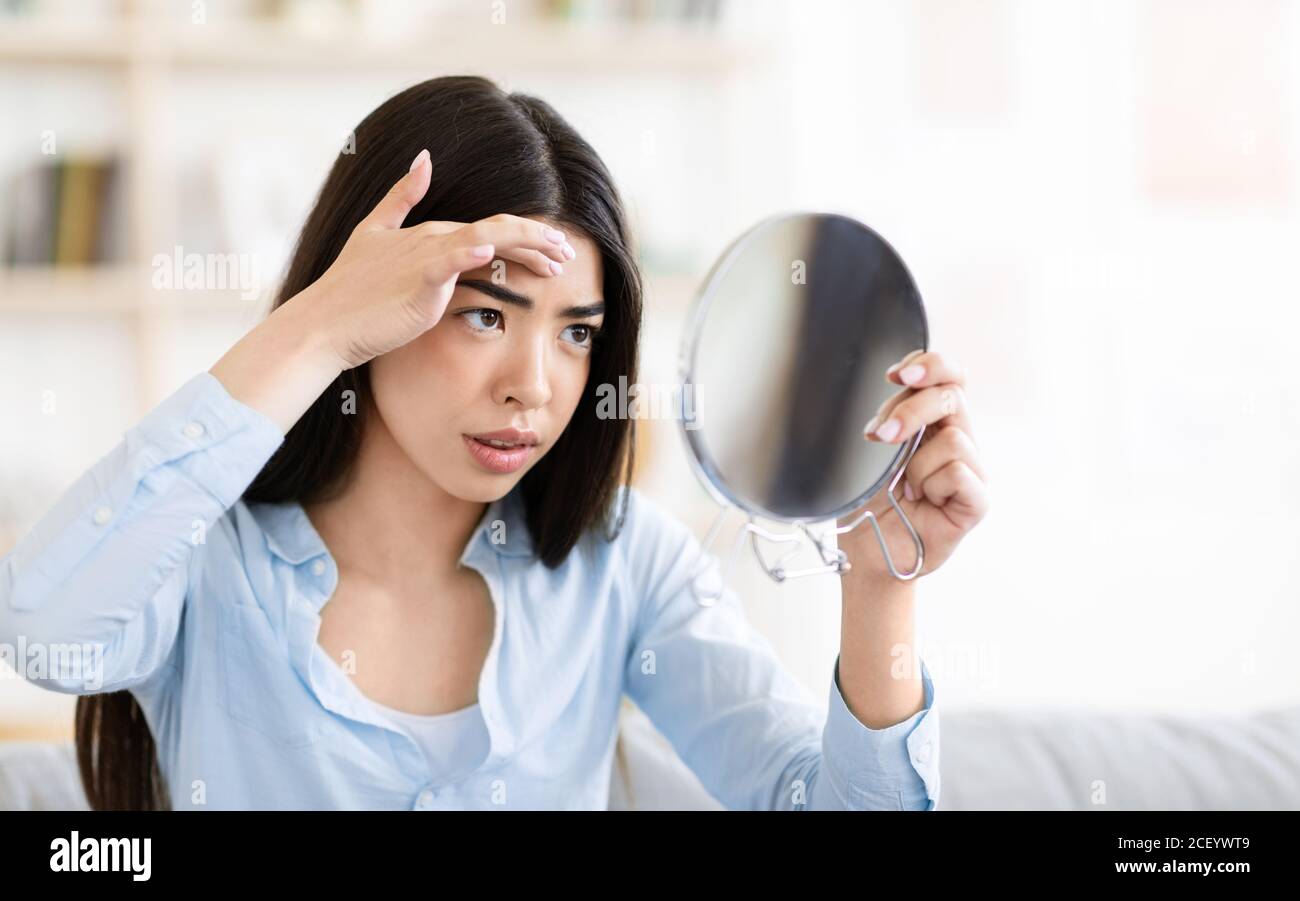 Problem Skin. Worry Asian Woman Looking In Round Mirror And Touching ...