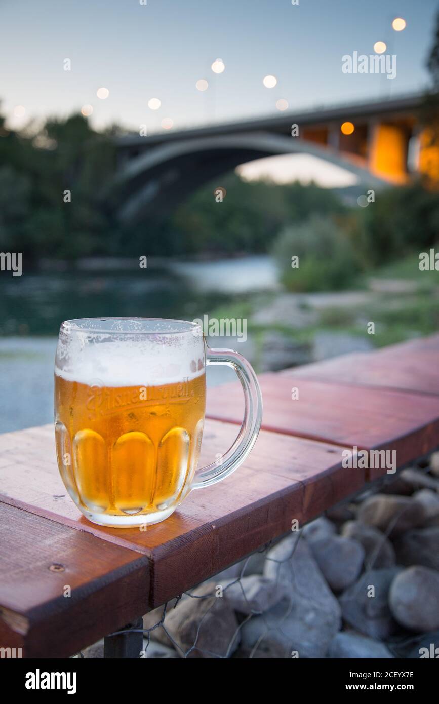 Large glass of Montenegro draught beer shining backlit by the afterglow ...