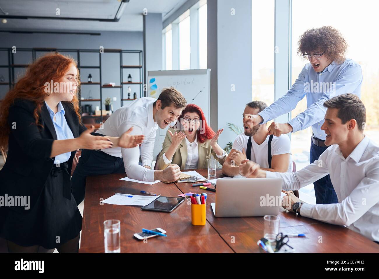 Young caucasian business co-workers shocked after successful final of ...