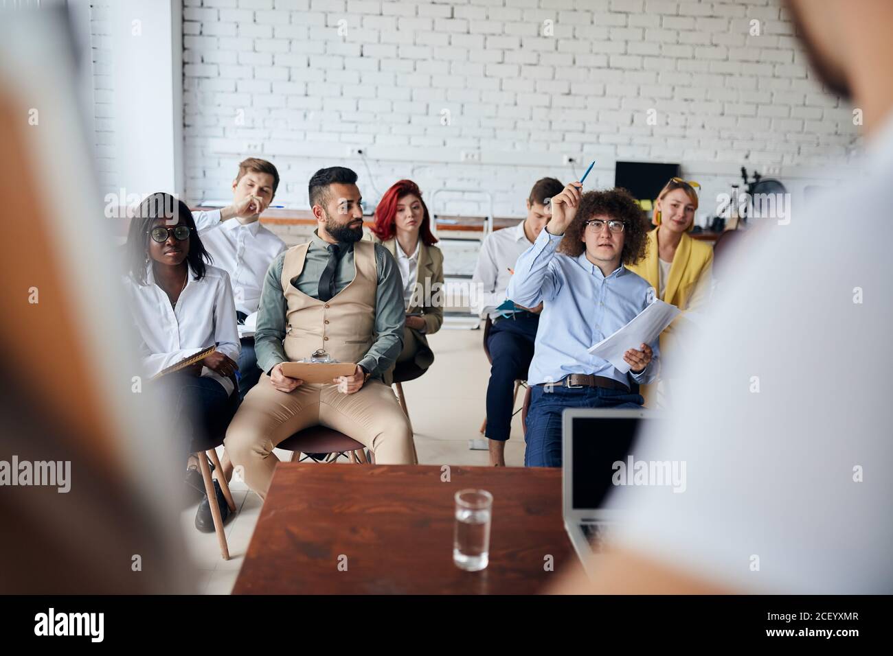 multiethnic group of young workers discuss ideas engaged in educational ...