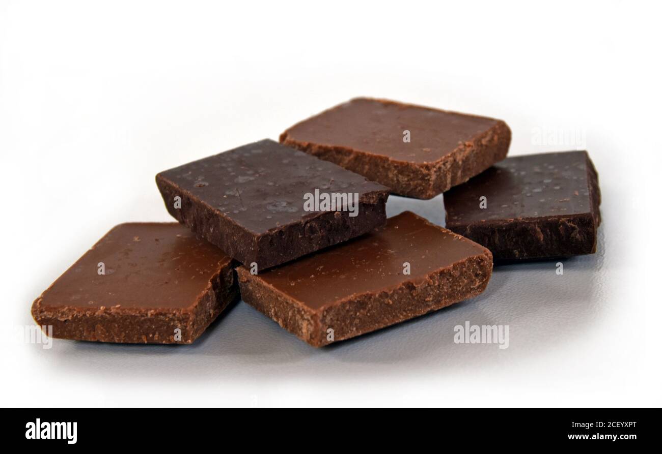 Milk and dark chocolate cubes. Chocolate stack on the white background ...