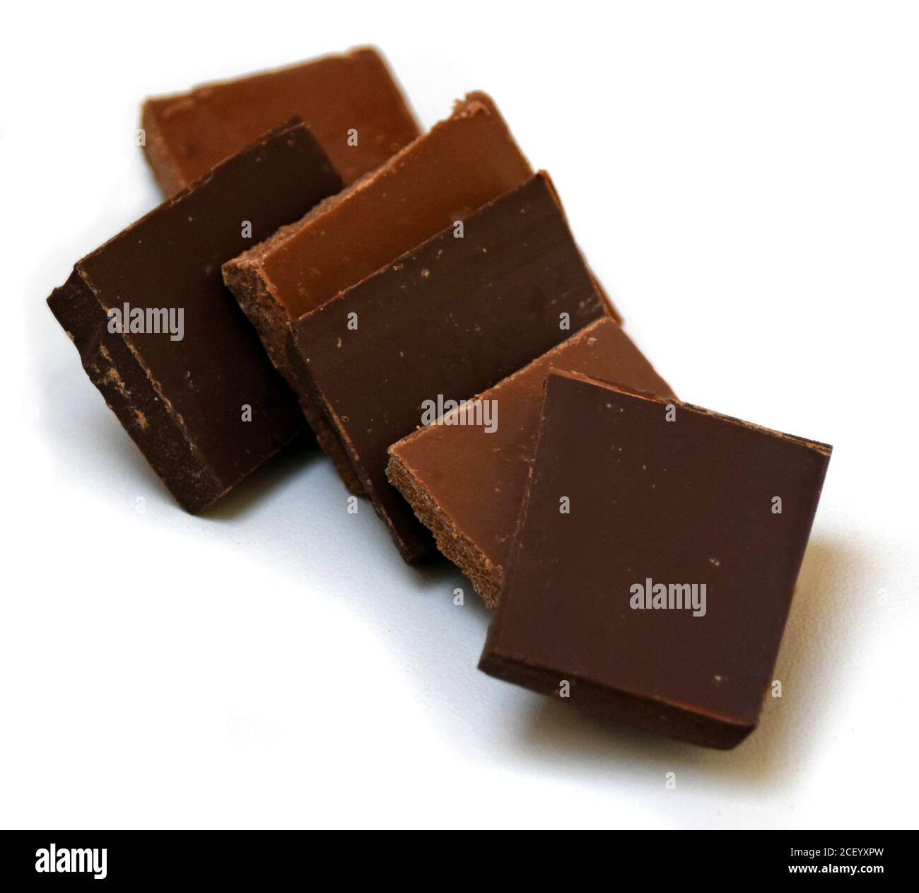 Milk and dark chocolate cubes. Chocolate stack on the white background ...