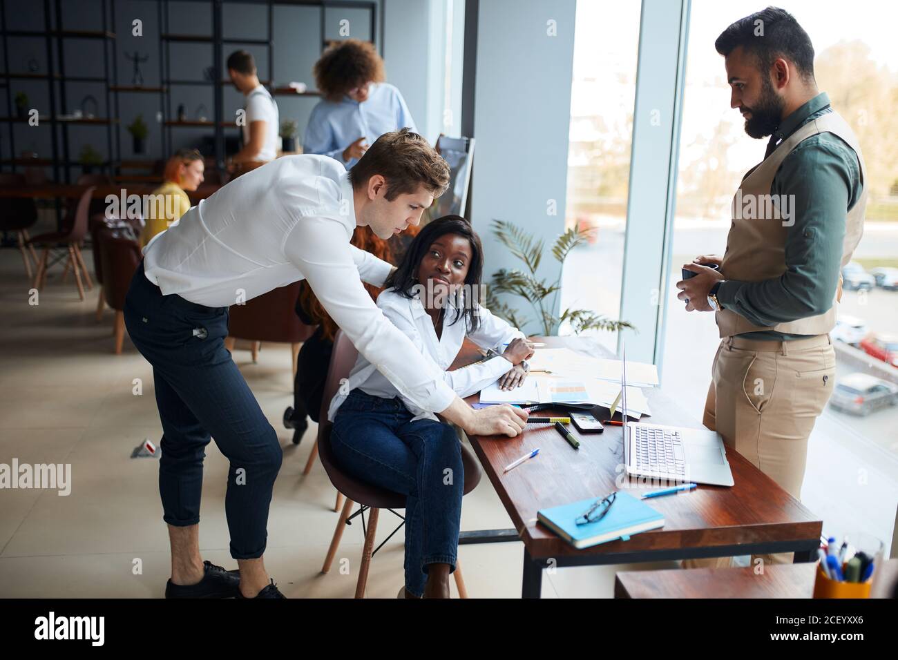 busy multi-ethnic business people working together in coworking space ...
