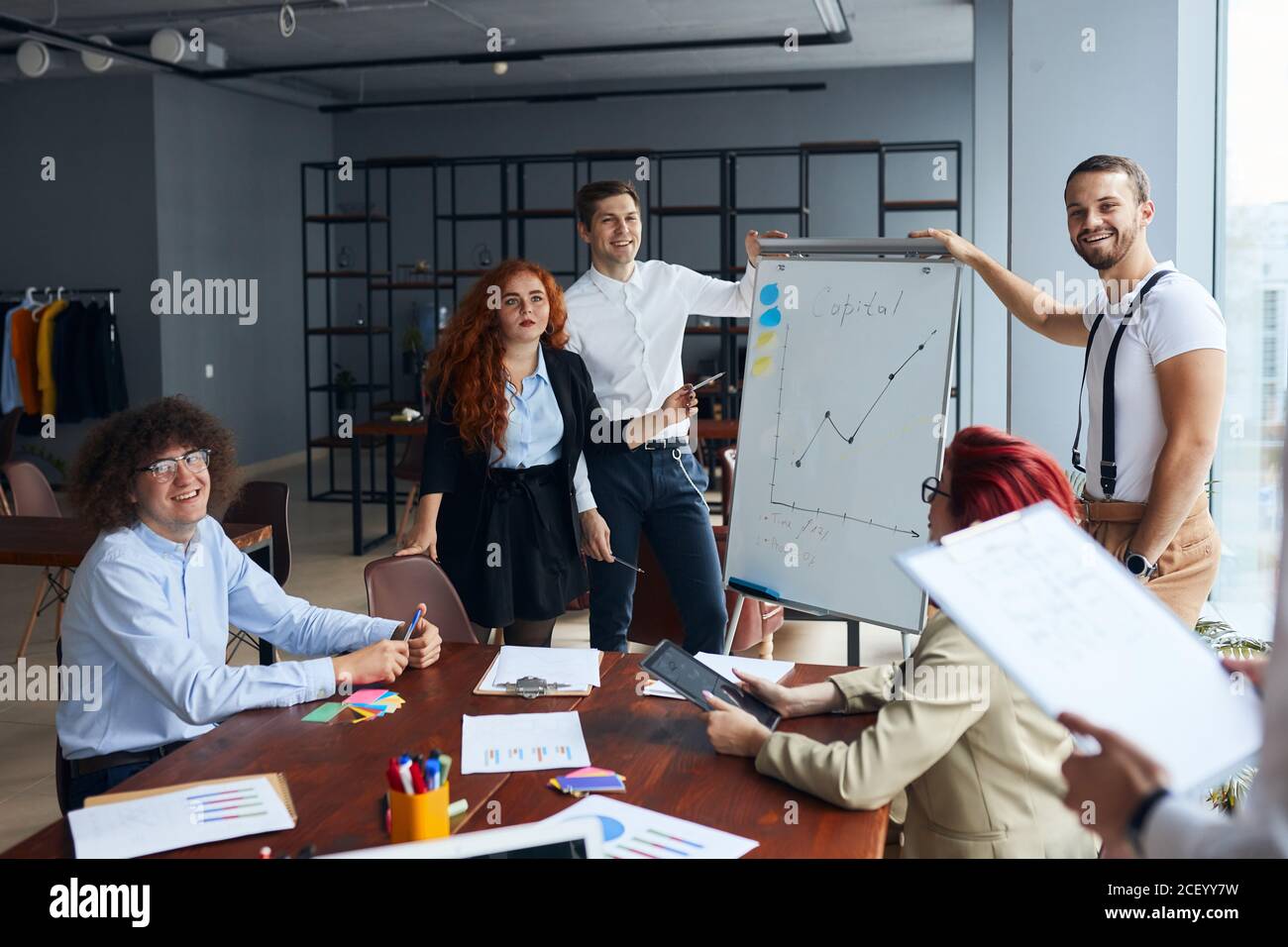 Positive good-looking people, business partners or colleague look at ...