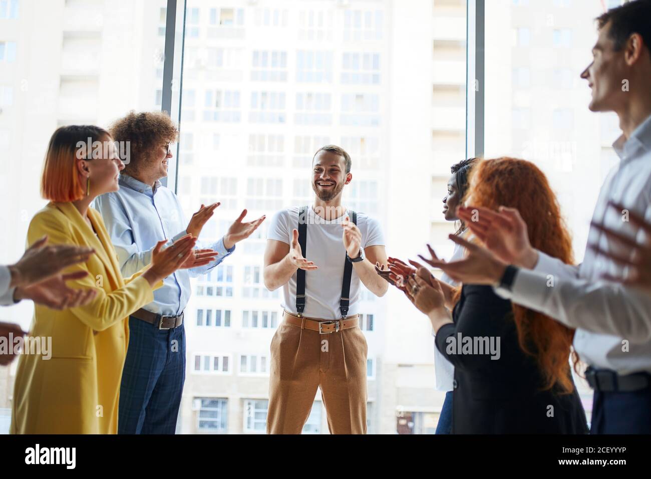 Happy business team clap their hands to co-worker for his great job ...