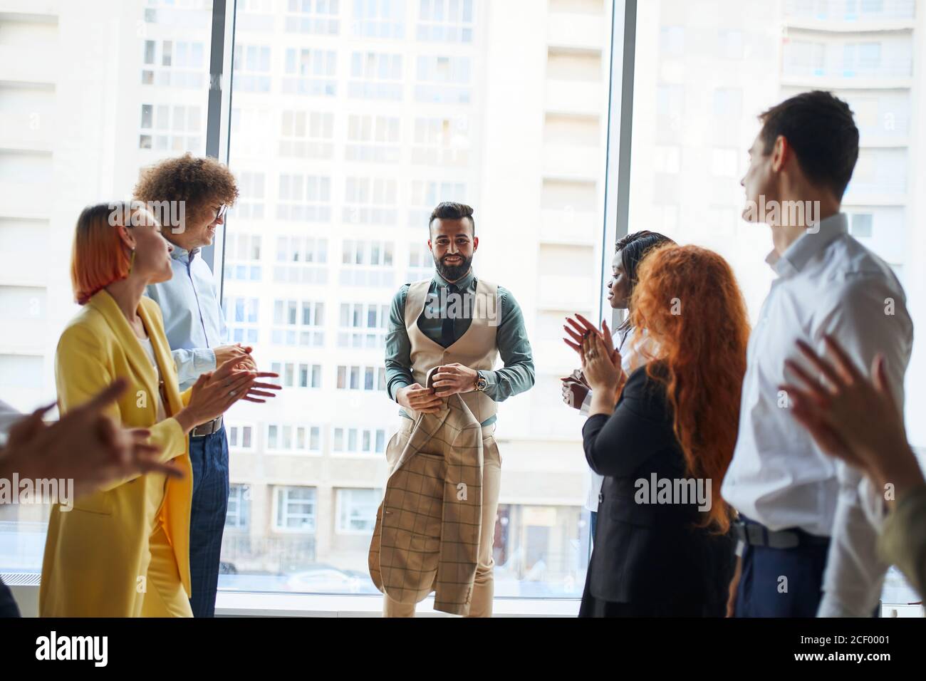 Happy business team clap their hands to co-worker for his great job ...